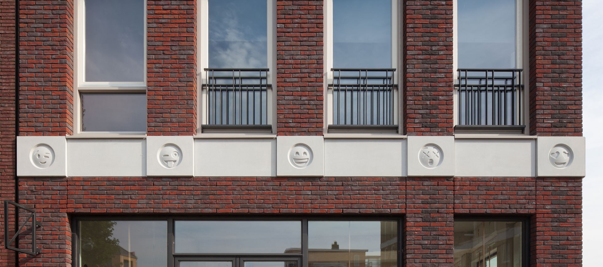 A building using emoji as modern gargoyles by Attika Architekten ...