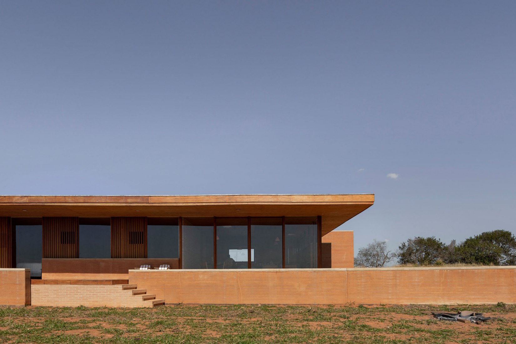 A house emerged from the red lands and the Cunha rolling landscape by ...