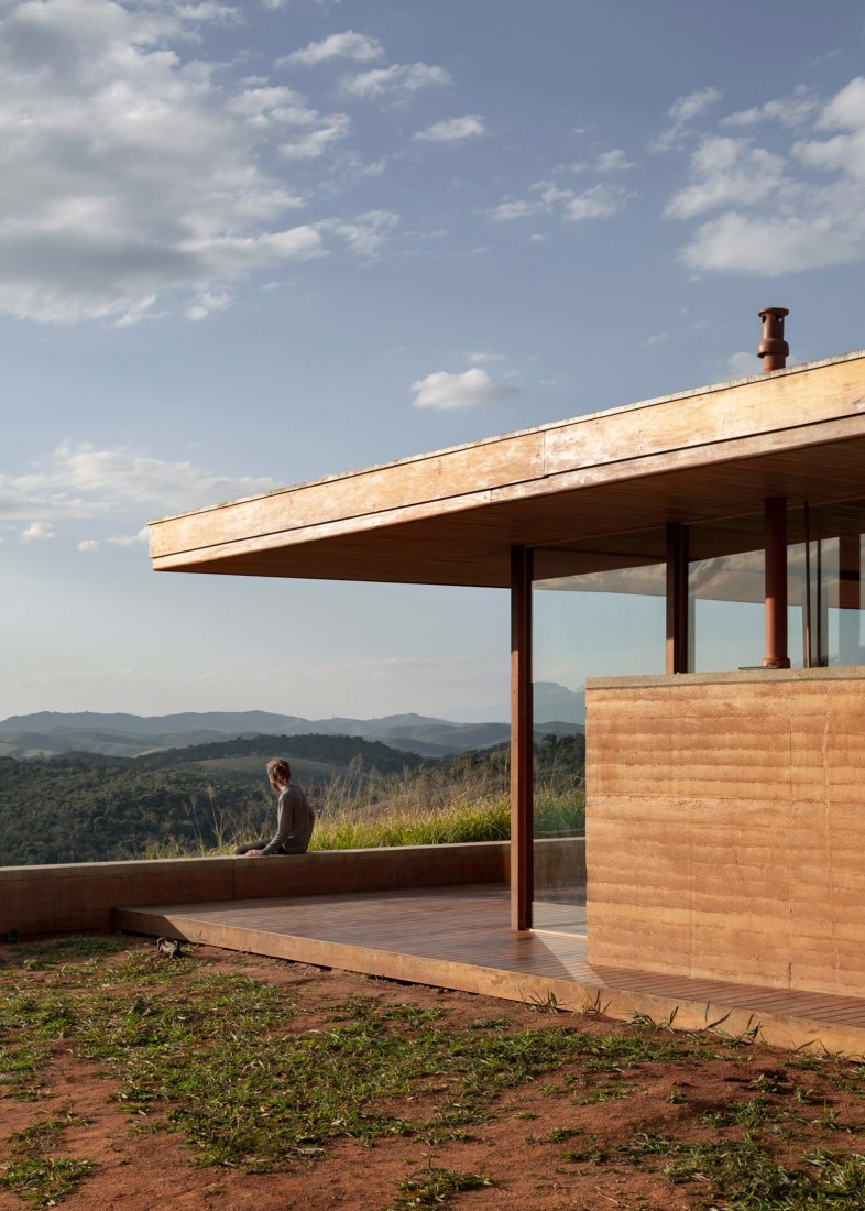 A house emerged from the red lands and the Cunha rolling landscape by ...