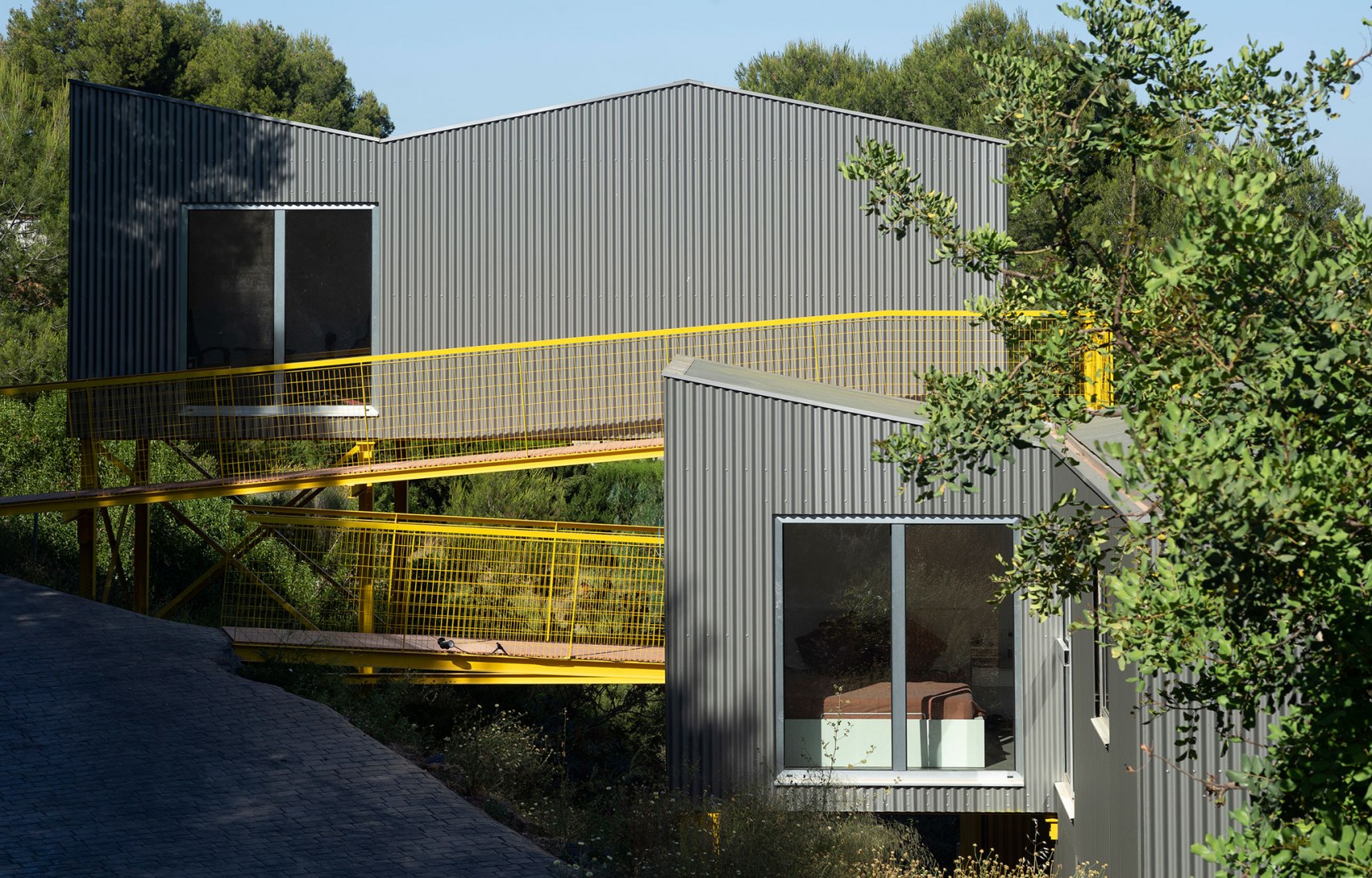A fragmented house on a slope. rNrH industrialized home by Juan Marco ...