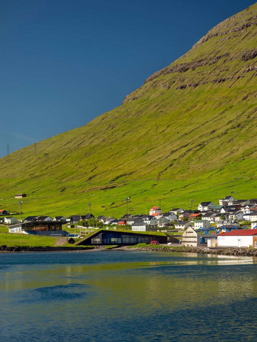A small town hall integrated in the distinctive Faroese nature by ...